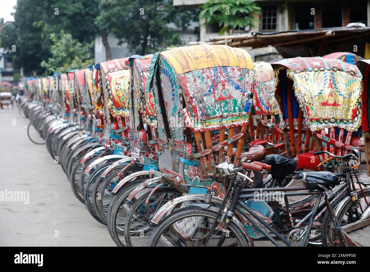 Dhaka, Bangladesh - July 20, 2024: Rows of rickshaws have been parked ...