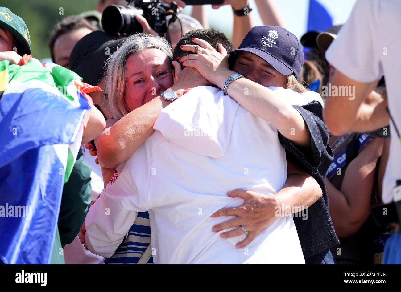 Great Britain's Tom Pidcock is congratulated by his family and partner ...