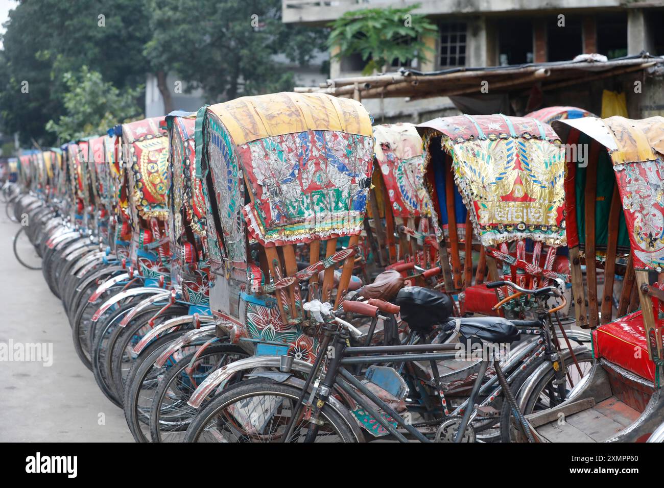 Dhaka, Bangladesh - July 20, 2024: Rows of rickshaws have been parked ...