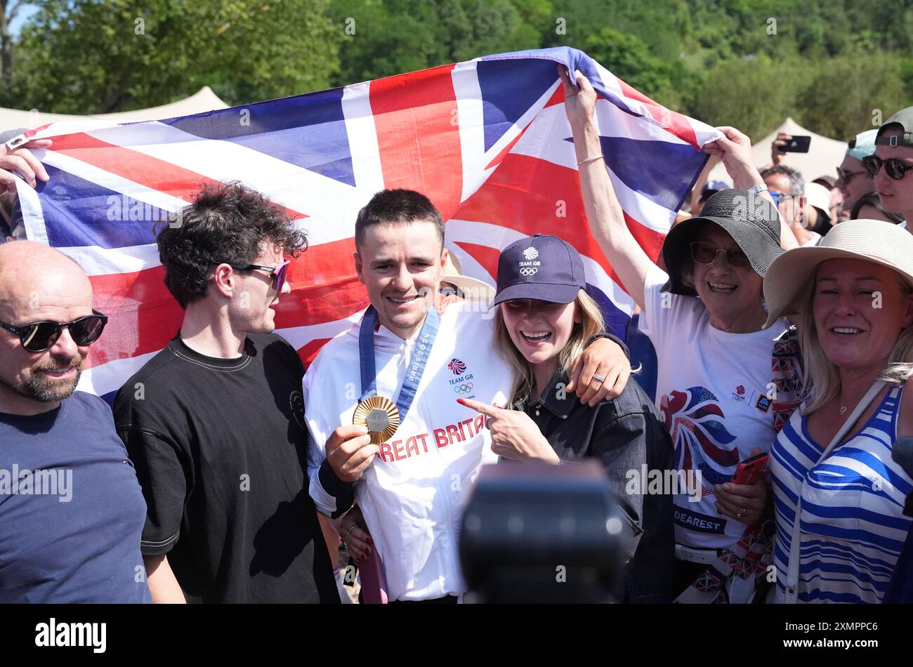 Great Britain's Tom Pidcock is congratulated by his family and partner ...