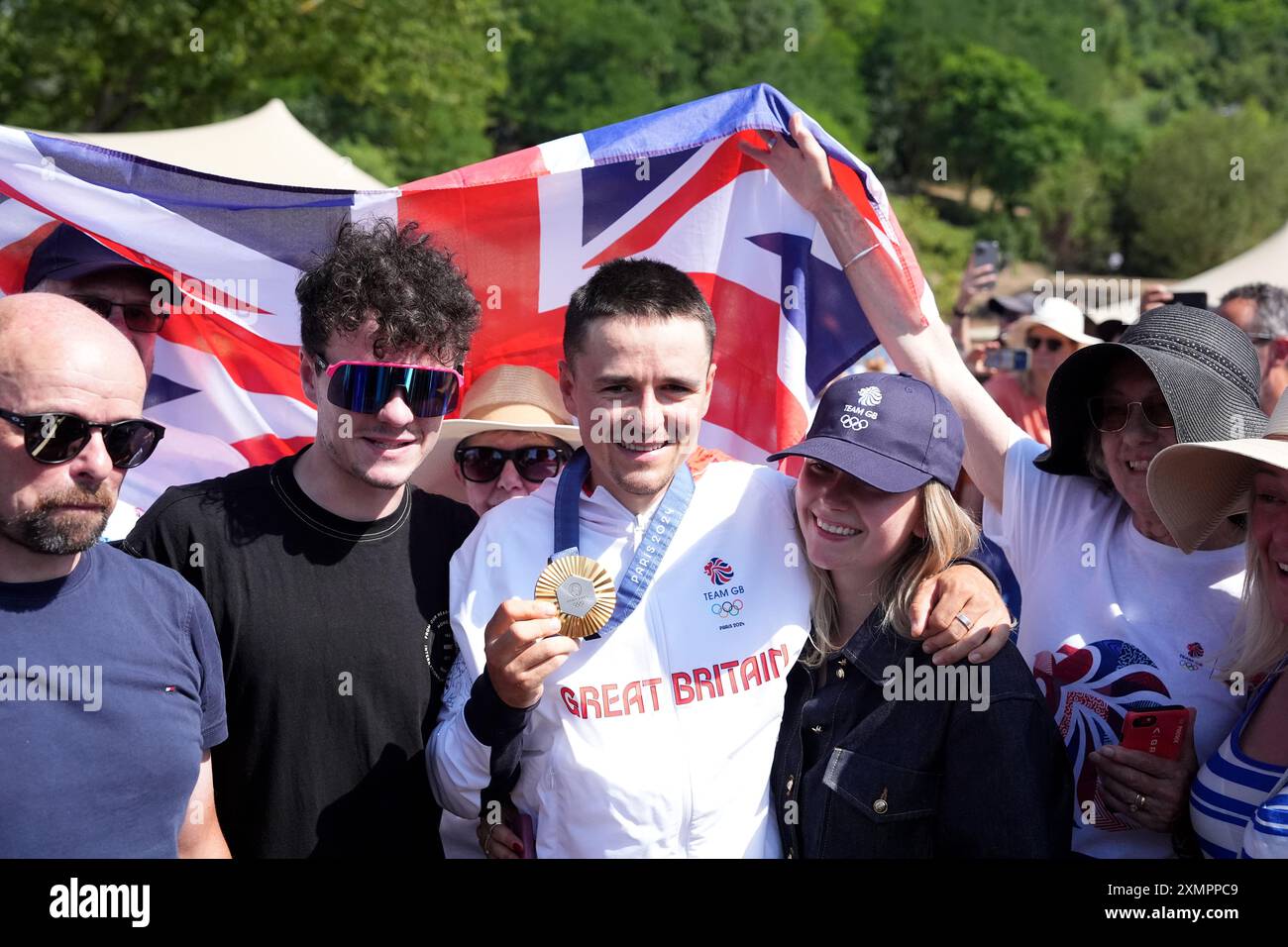 Great Britain's Tom Pidcock is congratulated by his family and partner ...