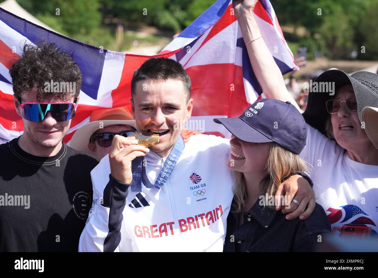 Great Britain's Tom Pidcock is congratulated by his family and partner ...