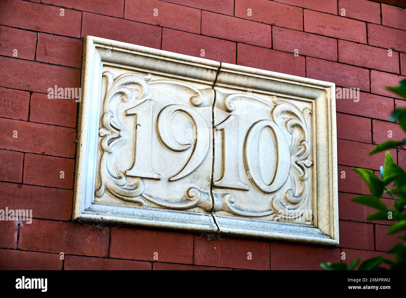 Ceramic date tile on side of building Stock Photo - Alamy