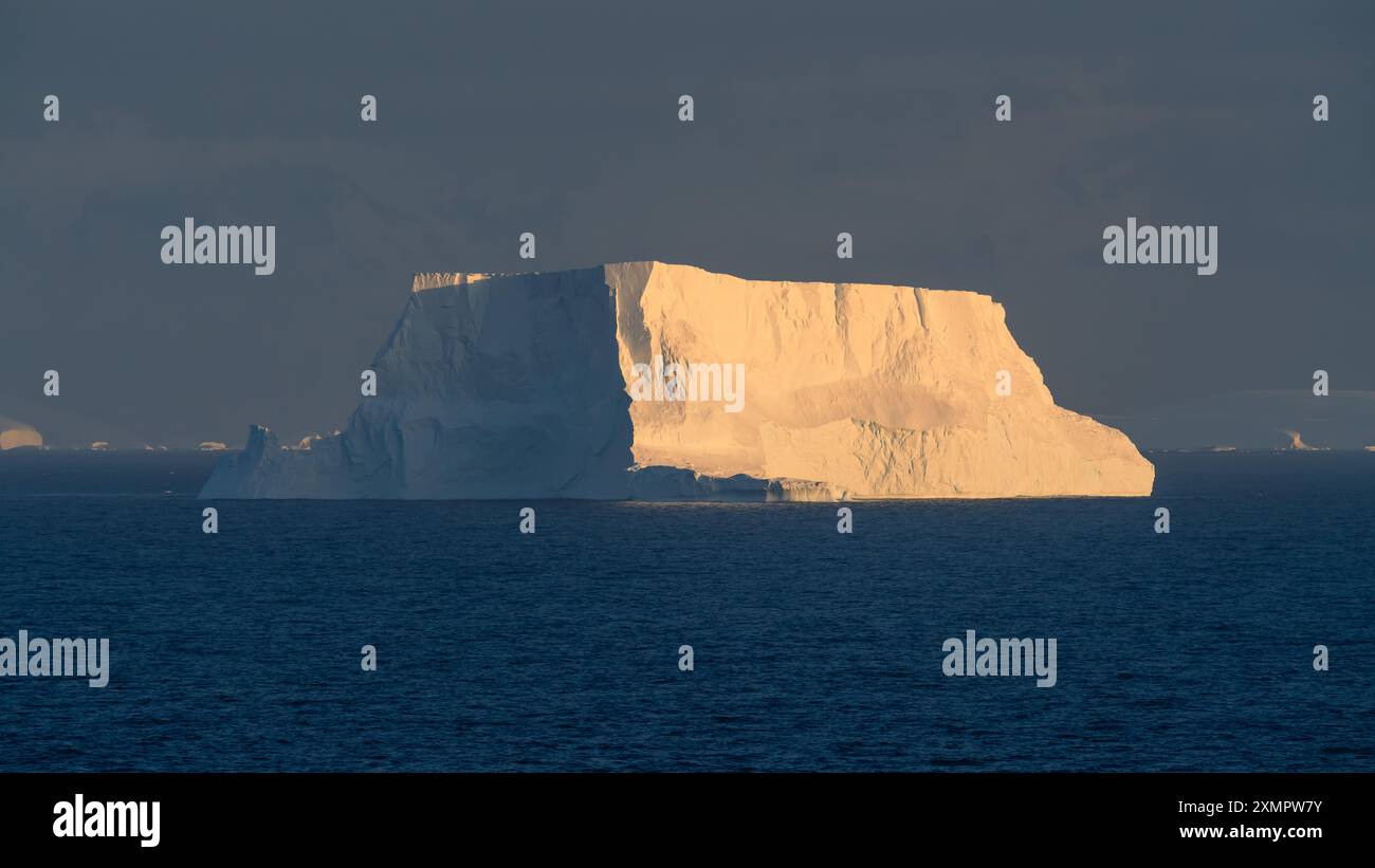 Powerful Iceberg Golden Hour Warm Light On One Side, Dark Blue On the ...