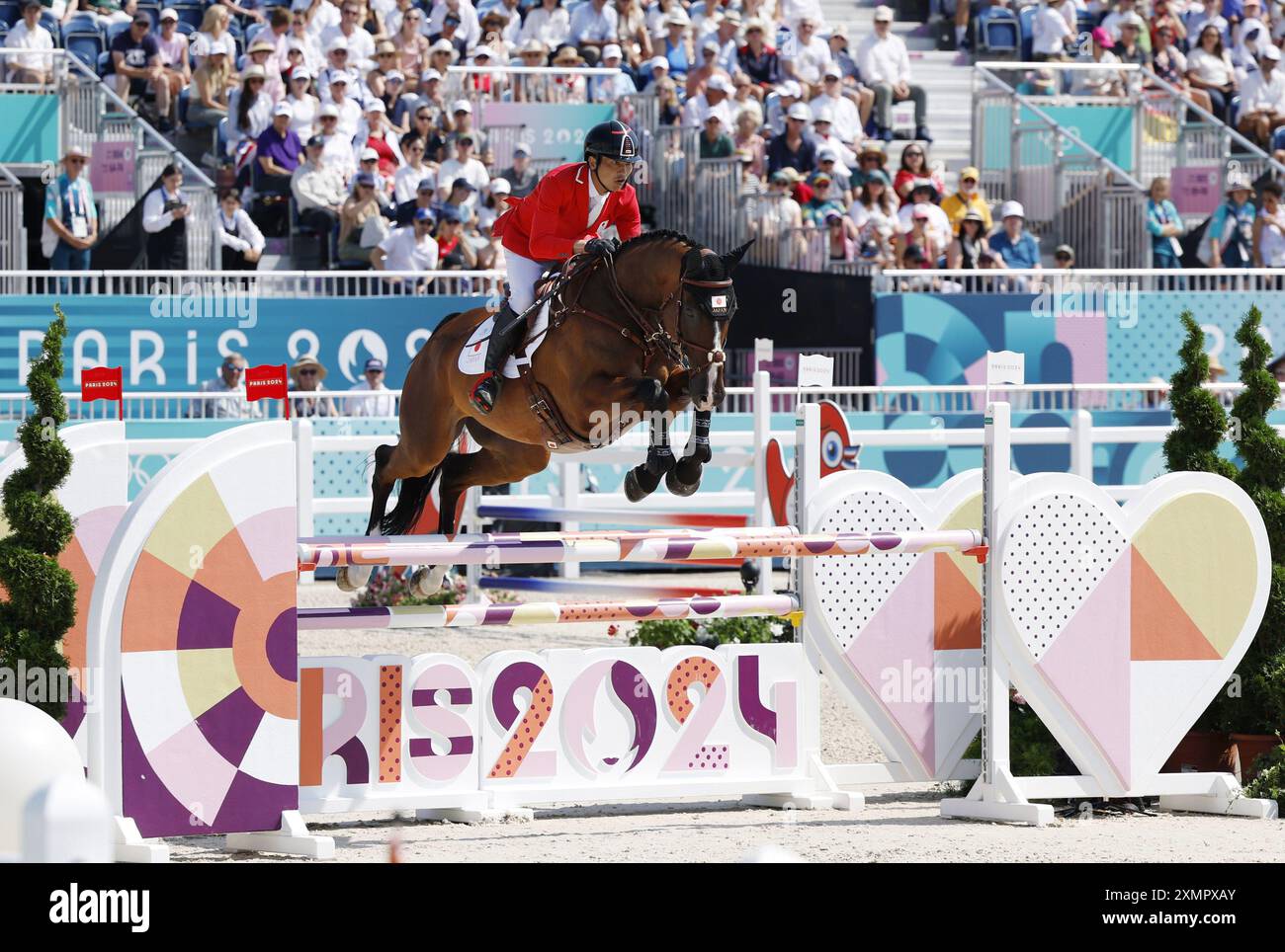 Toshiyuki Tanaka of Japan competes in the jumping phase of the Paris ...