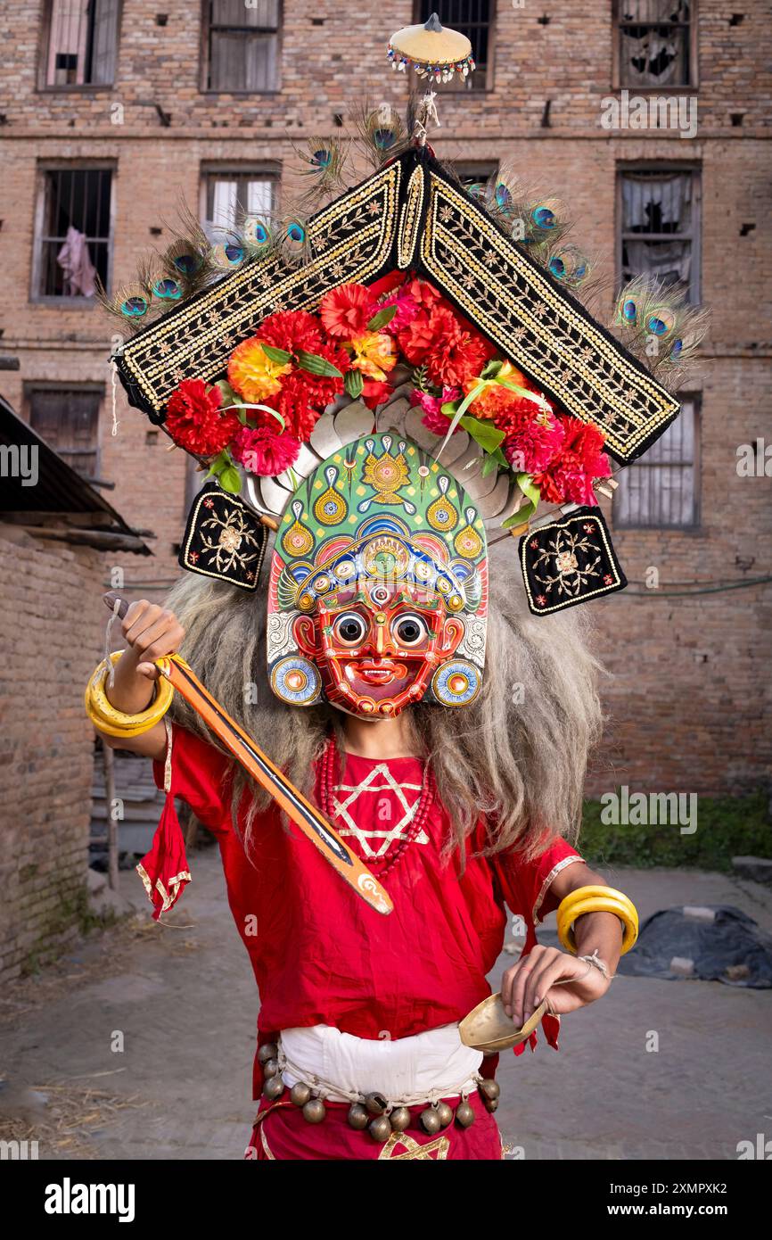 Traditional dancer Sroj Dilpakar, age 22, wears mask representing god ...