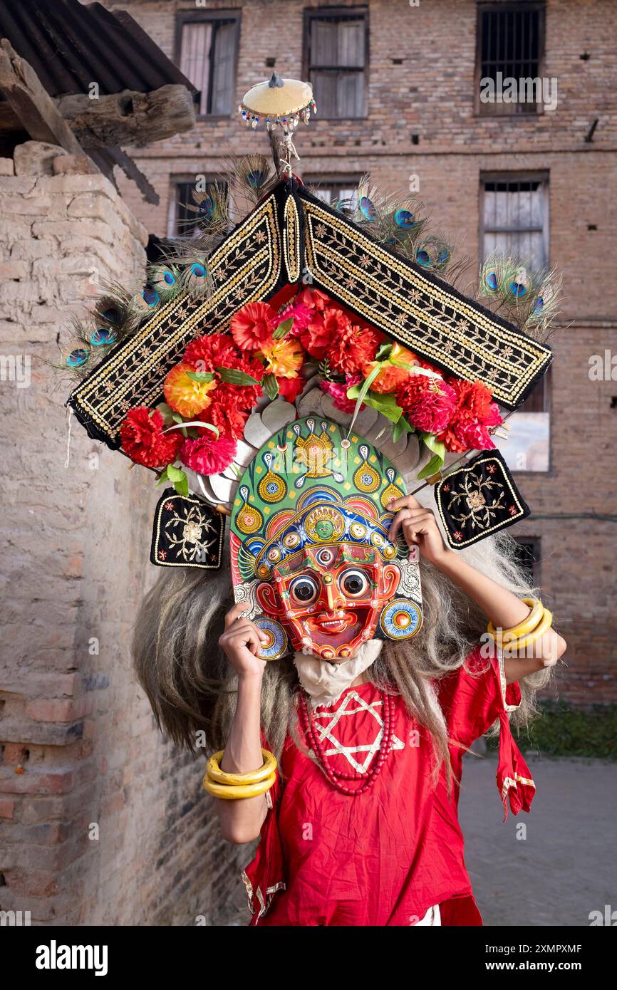 Traditional dancer Sroj Dilpakar, age 22, wears mask representing god ...