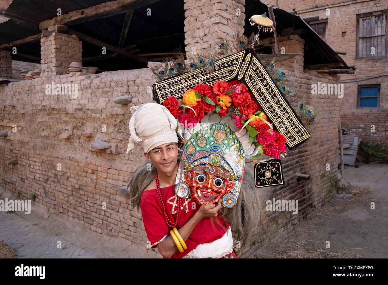 Traditional dancer Sroj Dilpakar, age 22, wears mask representing god ...