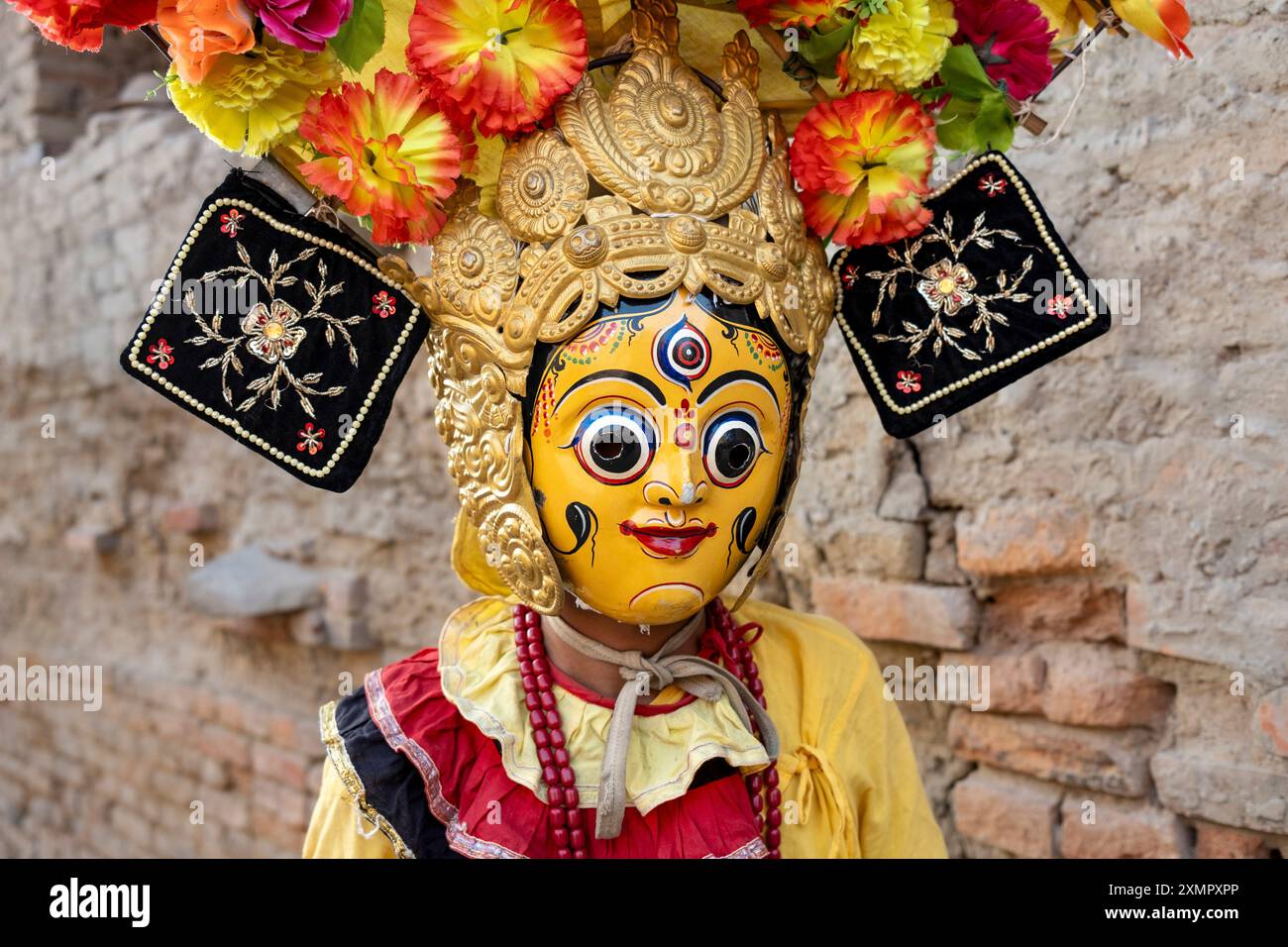 Traditional dancer Roshish Prajapati, age 18, wears mask representing ...