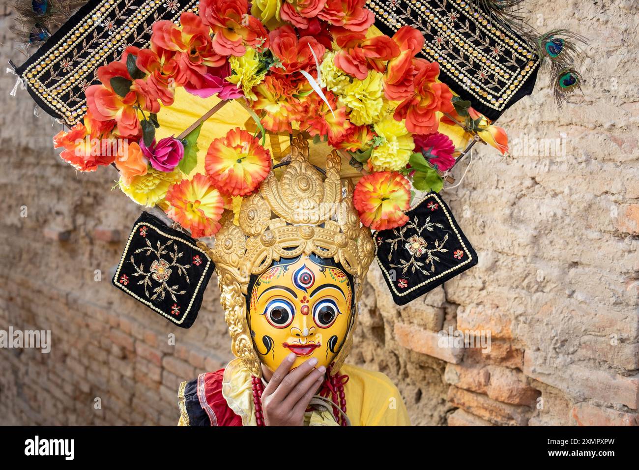 Traditional dancer Roshish Prajapati, age 18, wears mask representing ...