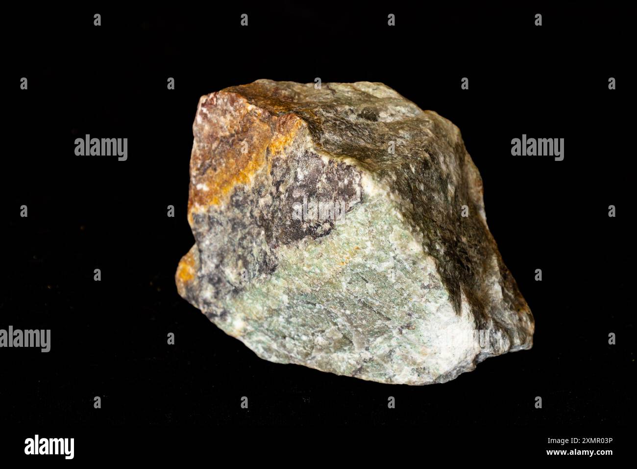 Layered purple an light green massive barite sample against a black ...