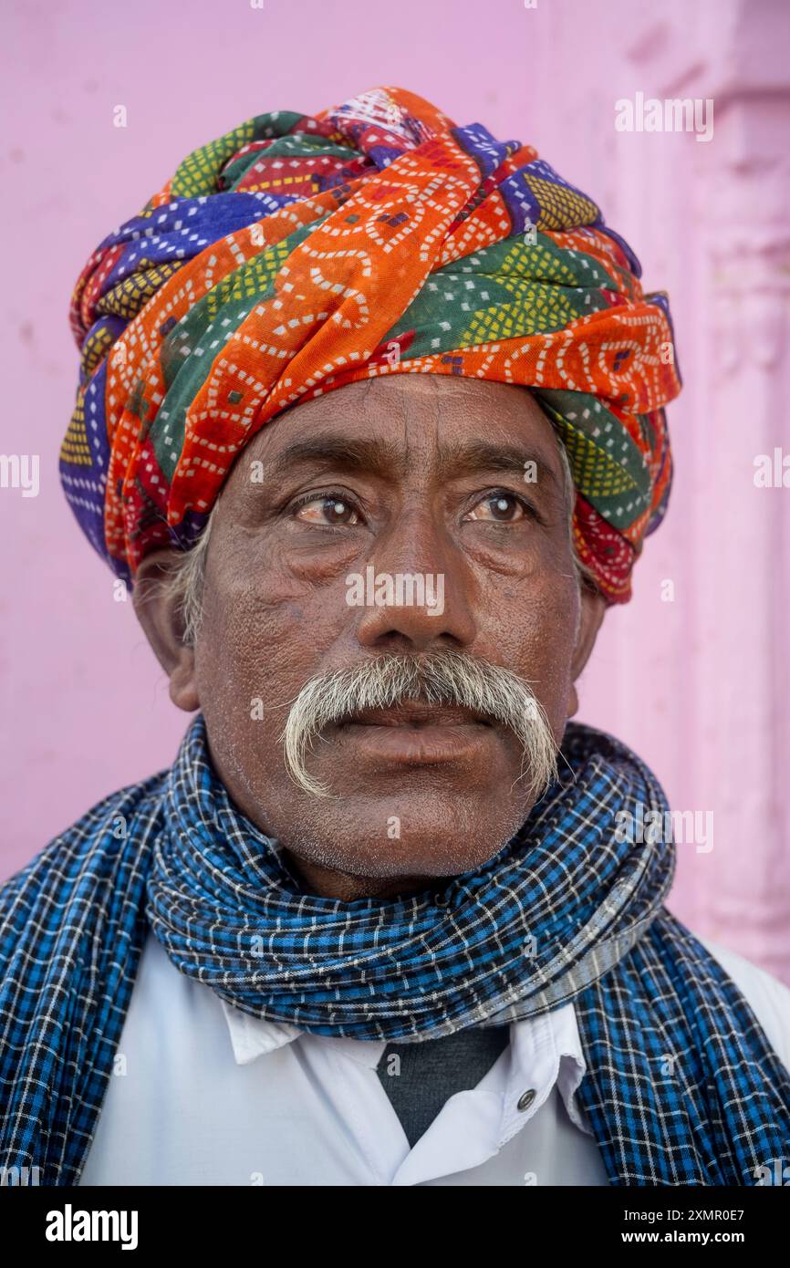 Wearing traditional dress man poses for portrait in street during ...
