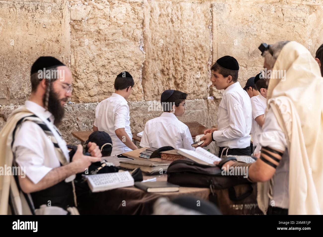 Male Jewish worshippers pray at the Western Wall men side. The Western ...