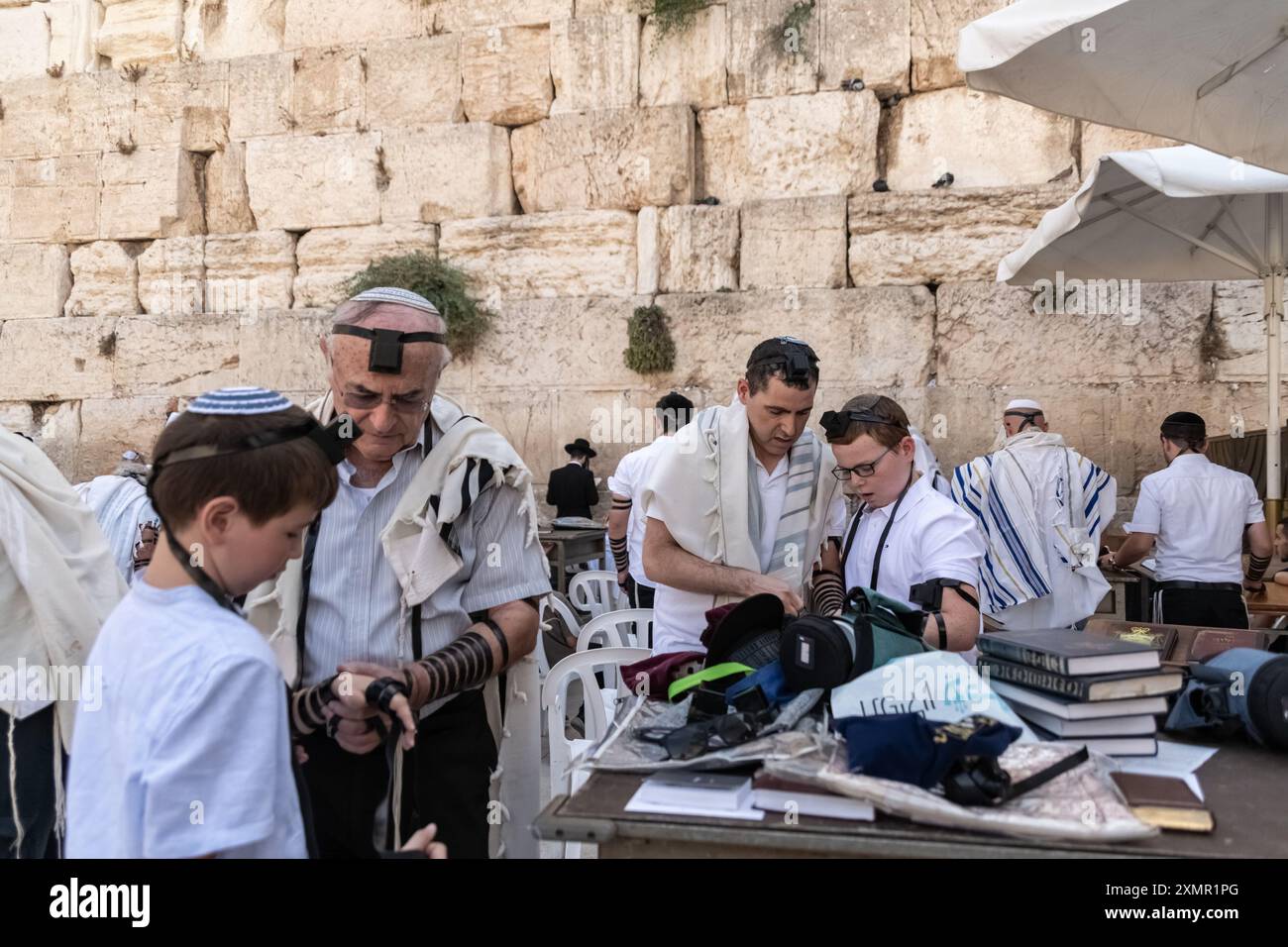 Jewish male worshippers prepare for a prayer at the Western Wall men ...