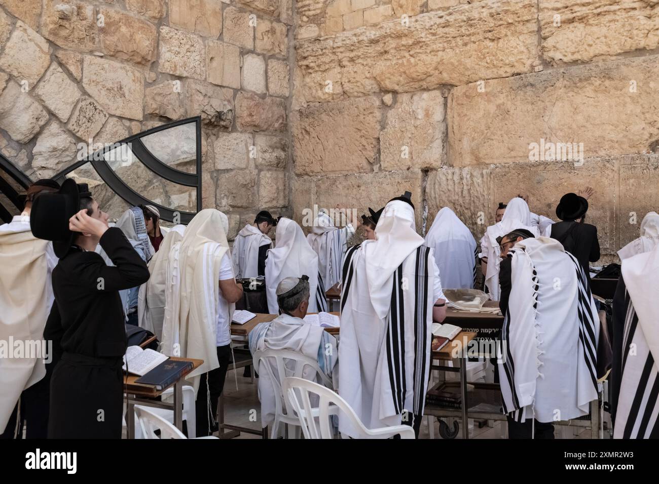 Male Jewish worshippers pray at the Western Wall men side. The Western ...
