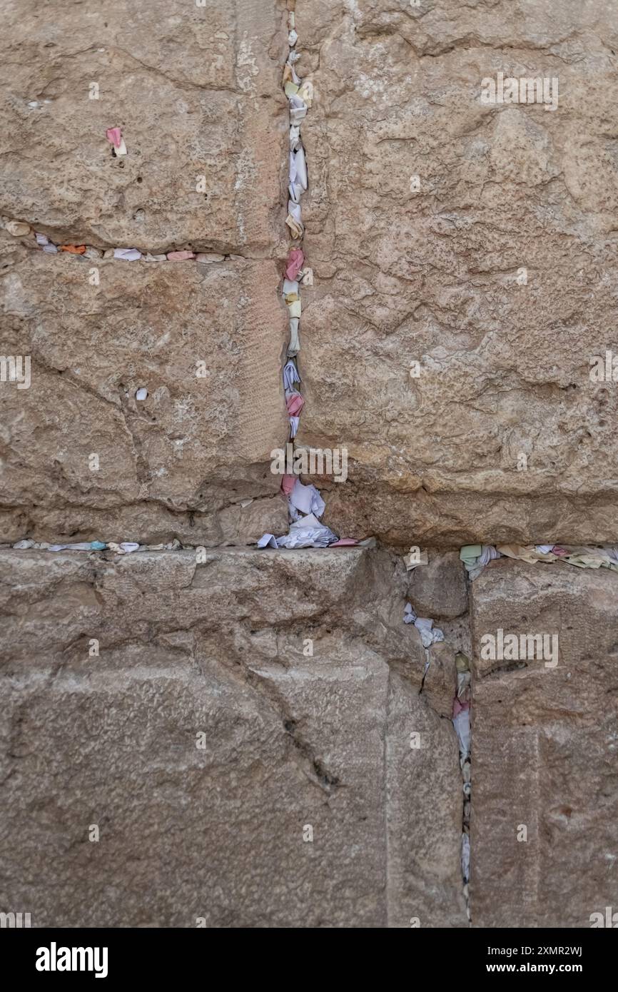Paper notes with blessings and prayers inside Western Wall cracks. The ...