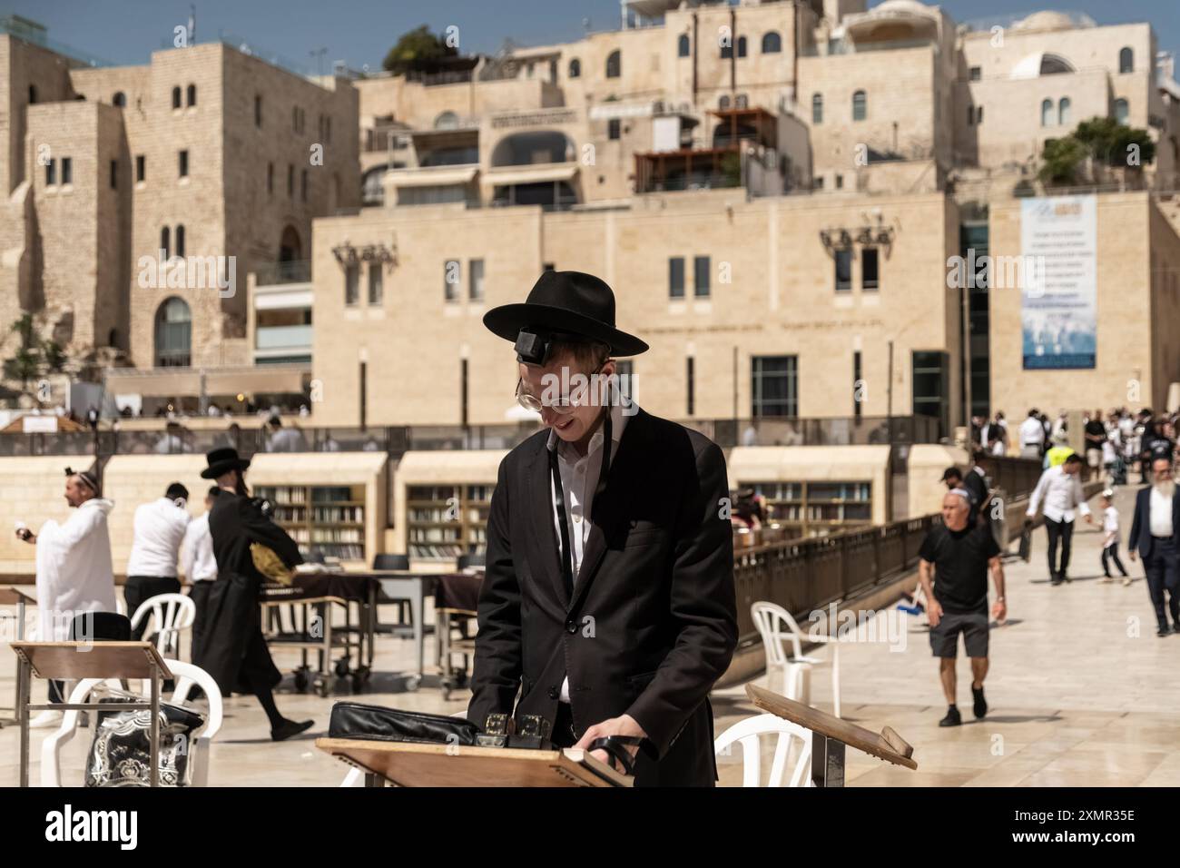 Male Jewish worshipper reads the Torah book at the Western Wall men ...