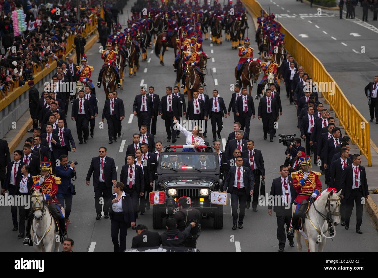 Peruvian President Dina Boluarte is surrounded by security as she waves ...