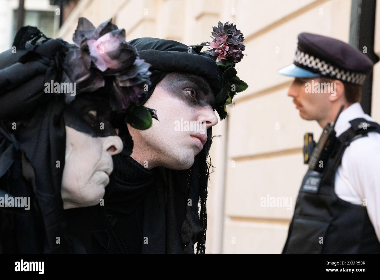 London, UK. 29 July, 2024. Activist mime troupe the 'Oil Slickers ...