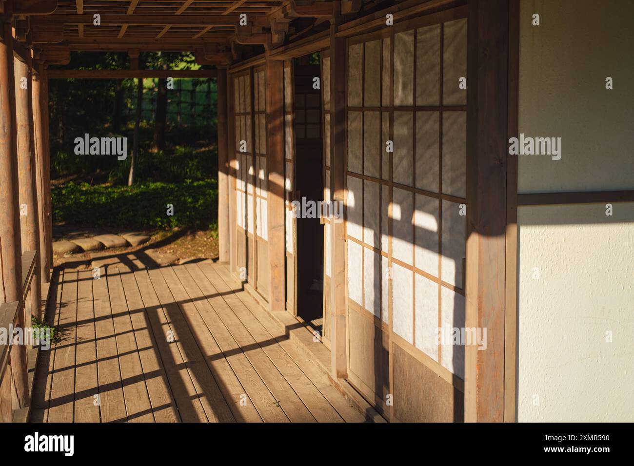 Wooden veranda with traditional Japanese shoji doors in sunlight ...
