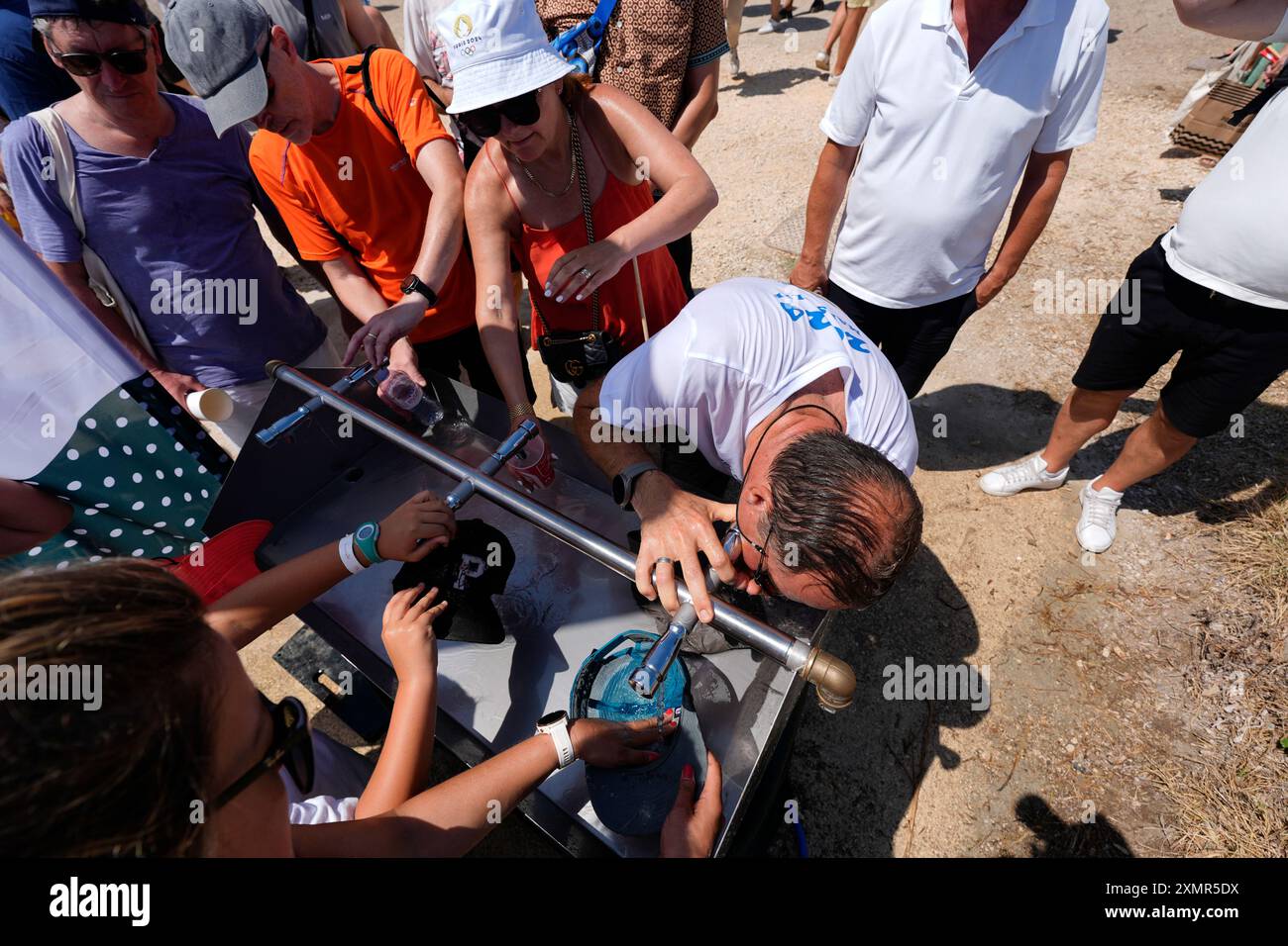 Sailing fans attempt to stay cool under the scorching sun after races ...