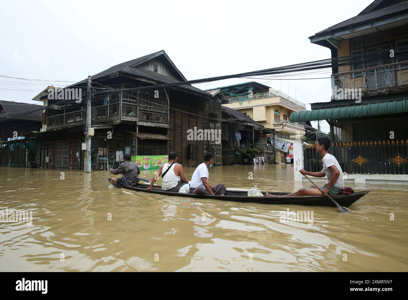 Bago. 29th July, 2024. People row a wooden boat on flood water in Bago ...