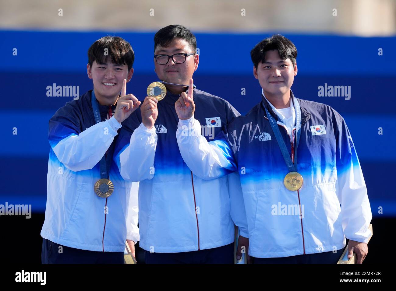 Gold medal winners, South Korea's Je Deok Kim, left, Woojin Kim, center, Wooseok Lee, right ...