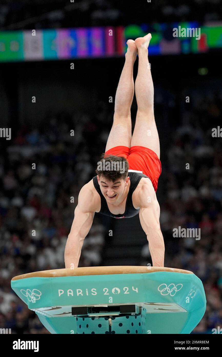 Luca Giubellini, of Switzerland, performs on the vault during the men's ...