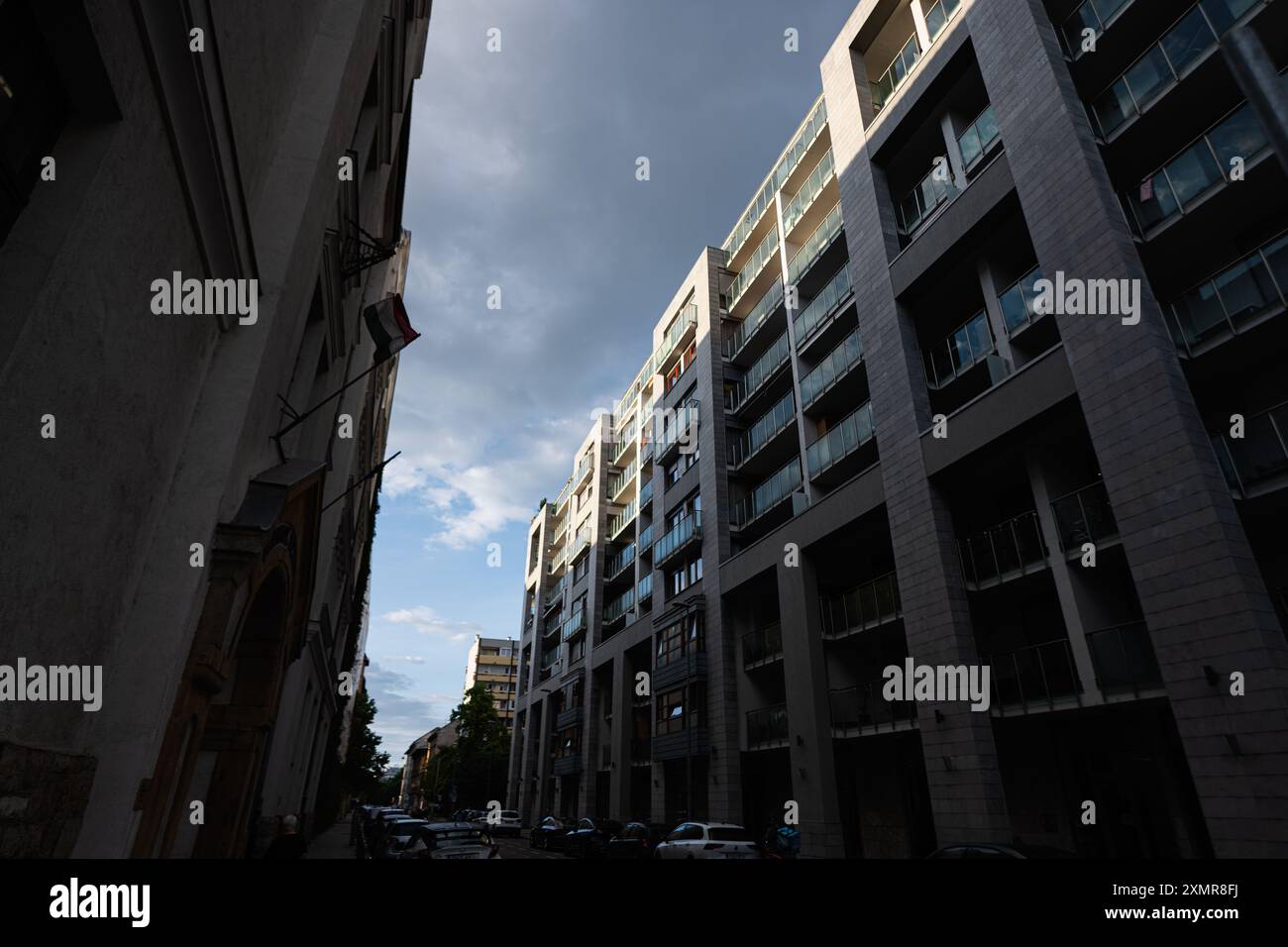 Urban street scene featuring modern high-rise buildings with a dramatic ...