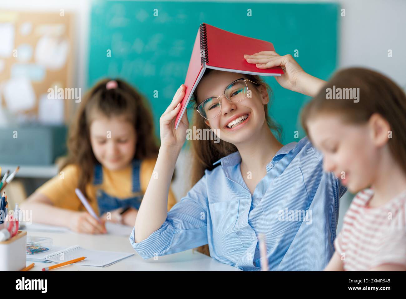 Happy kids at school. Children are learning in the class Stock Photo ...