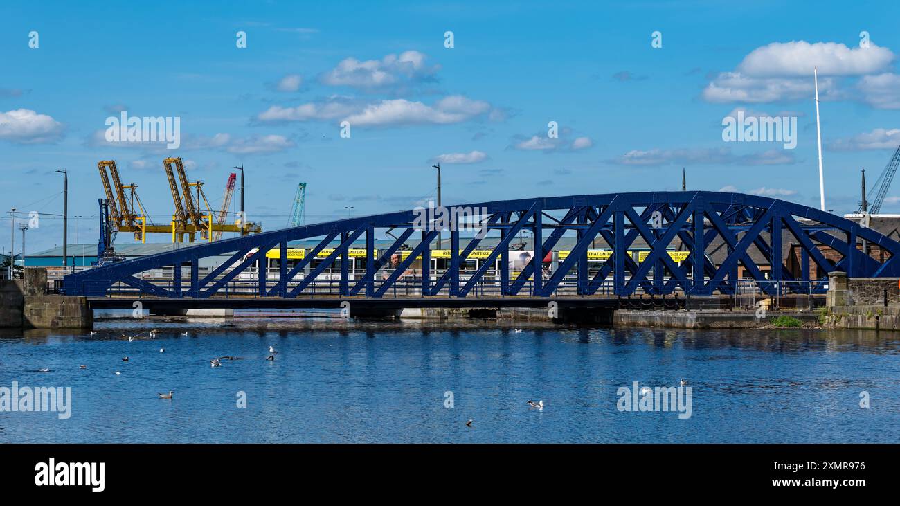 Newly restored cast iron swing bridge Victoria Bridge with tram passing ...