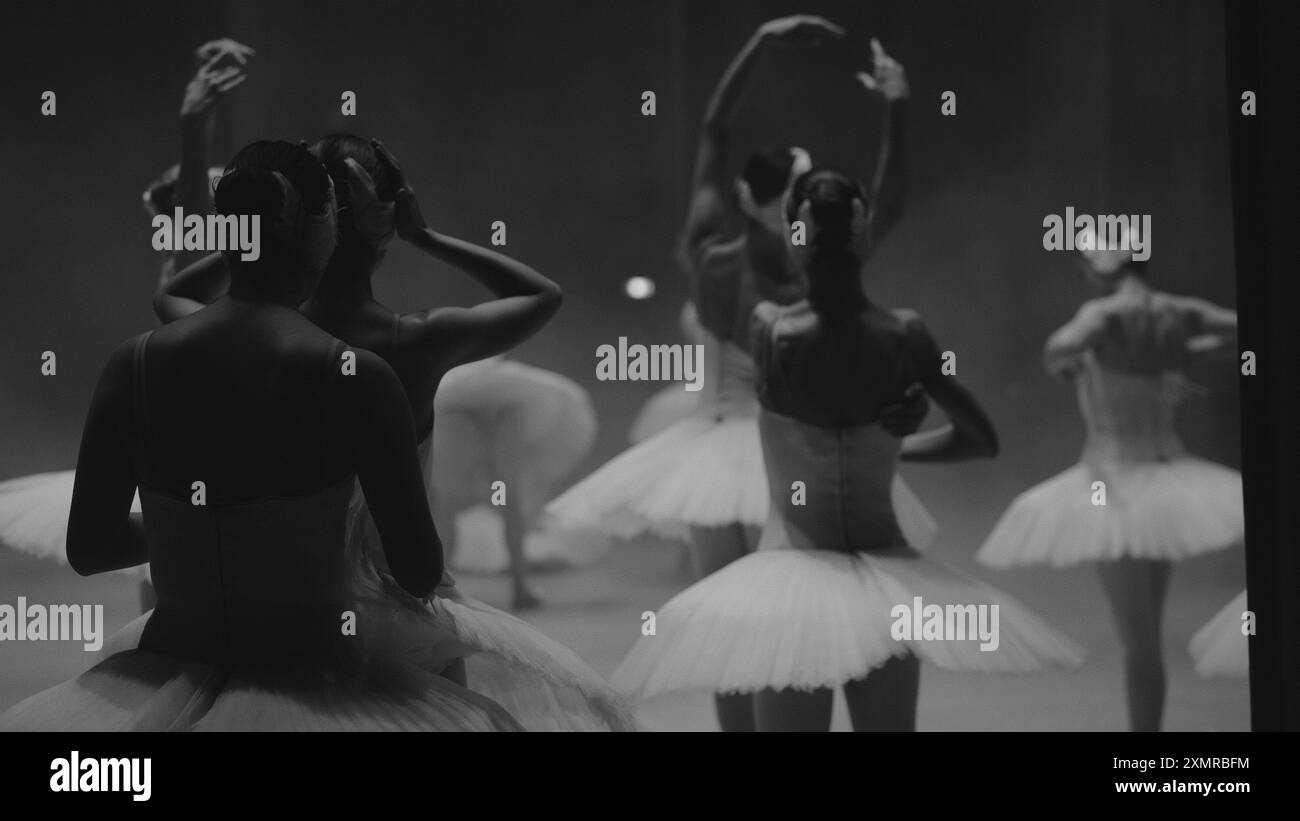 Ballerinas in white tutus, view from backstage. Black and white photos ...