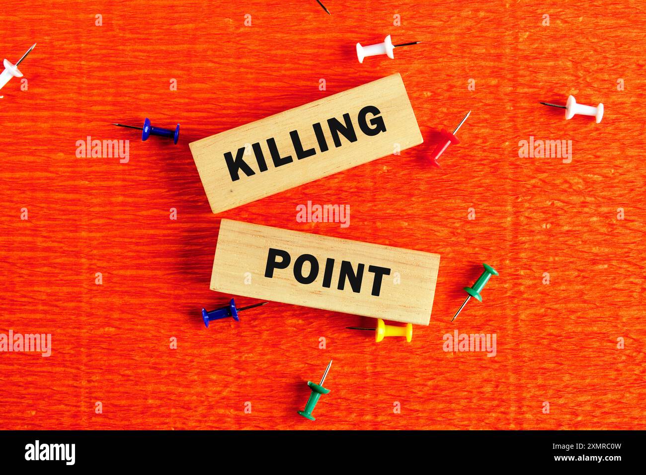 Word KILLING POINT Written the inscription on the blocks on an orange ...