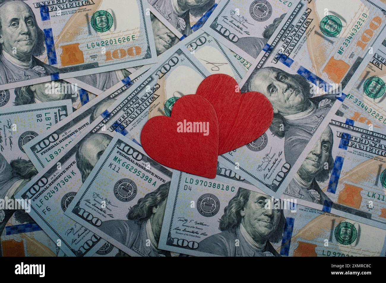 Red hearts on dollar bills. Concept of selling love for money Stock ...