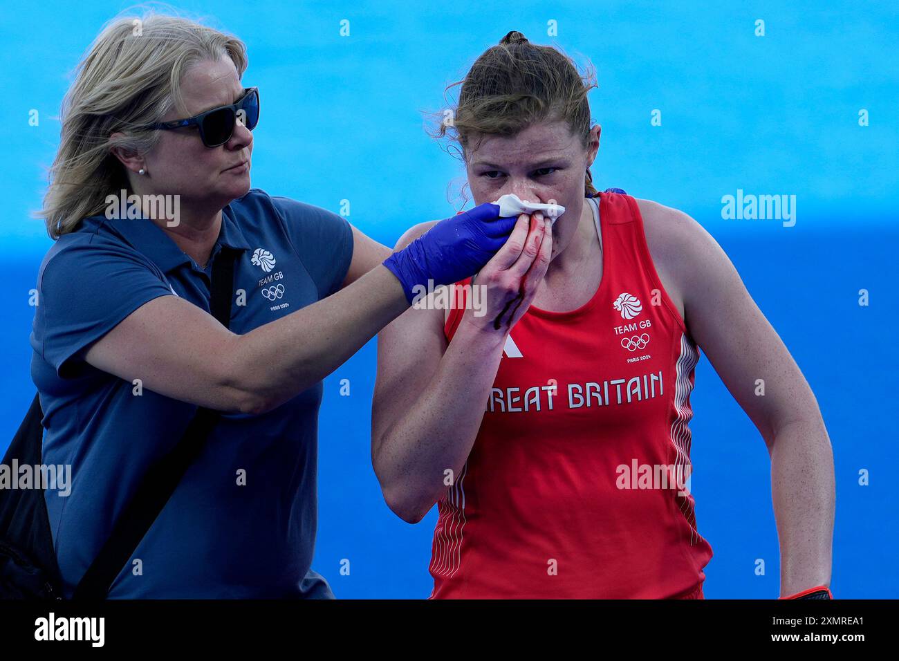 Britain's Tessa Howard is helped by an assistant who got injured after ...