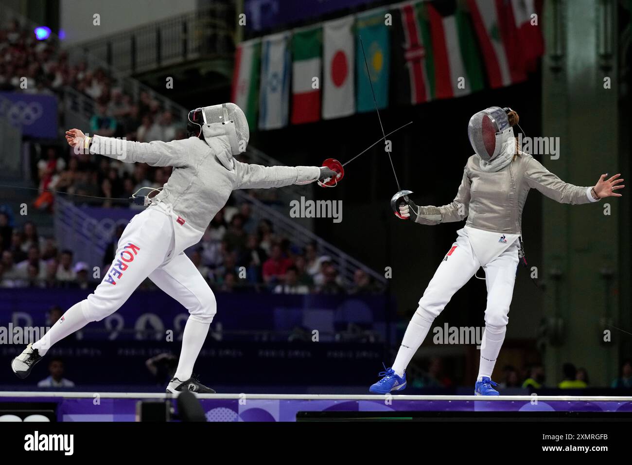 South Korea's Choi Sebin, left competes with France's Manon Apithy ...