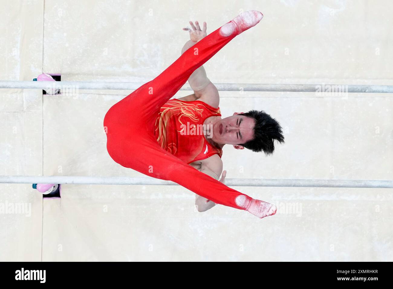 Zhang Boheng of China performs on the parallel bars during the men's ...