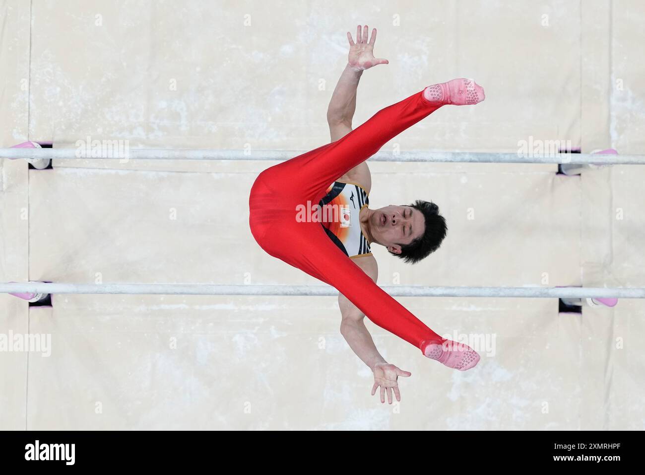 Wataru Tanigawa of Japan performs on the parallel bars during the men's ...