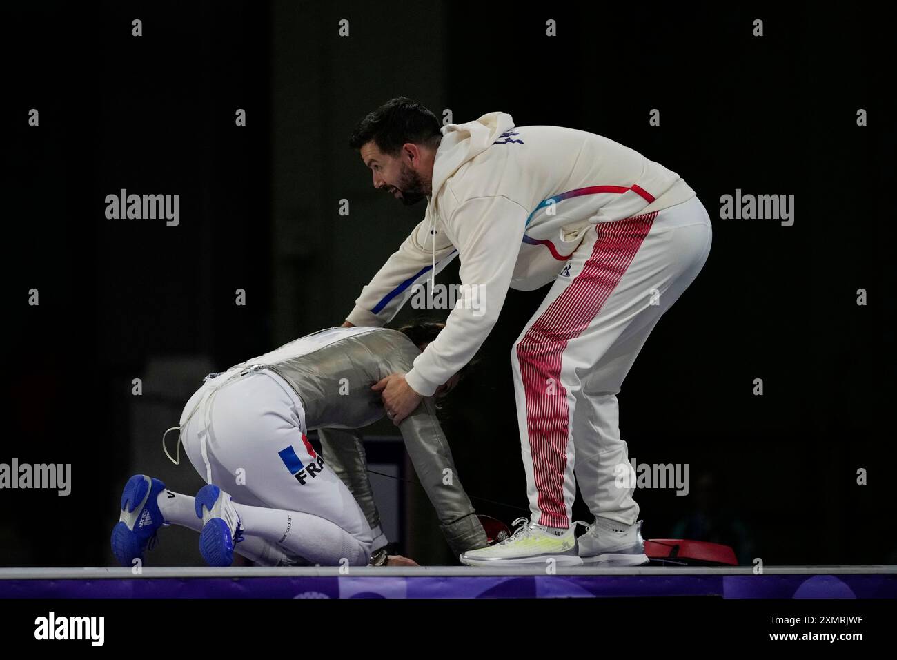 France's Manon Apithy Brunet celebrates with her coach after winning ...