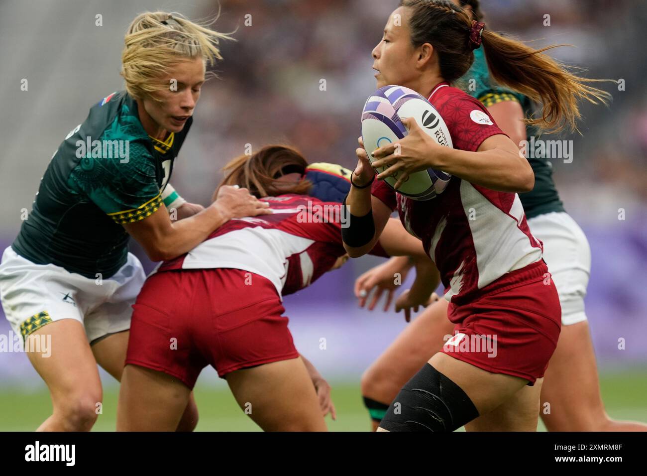 Japan's Hanako Utsumi gets past South Africa's Nadine Roos, left ...