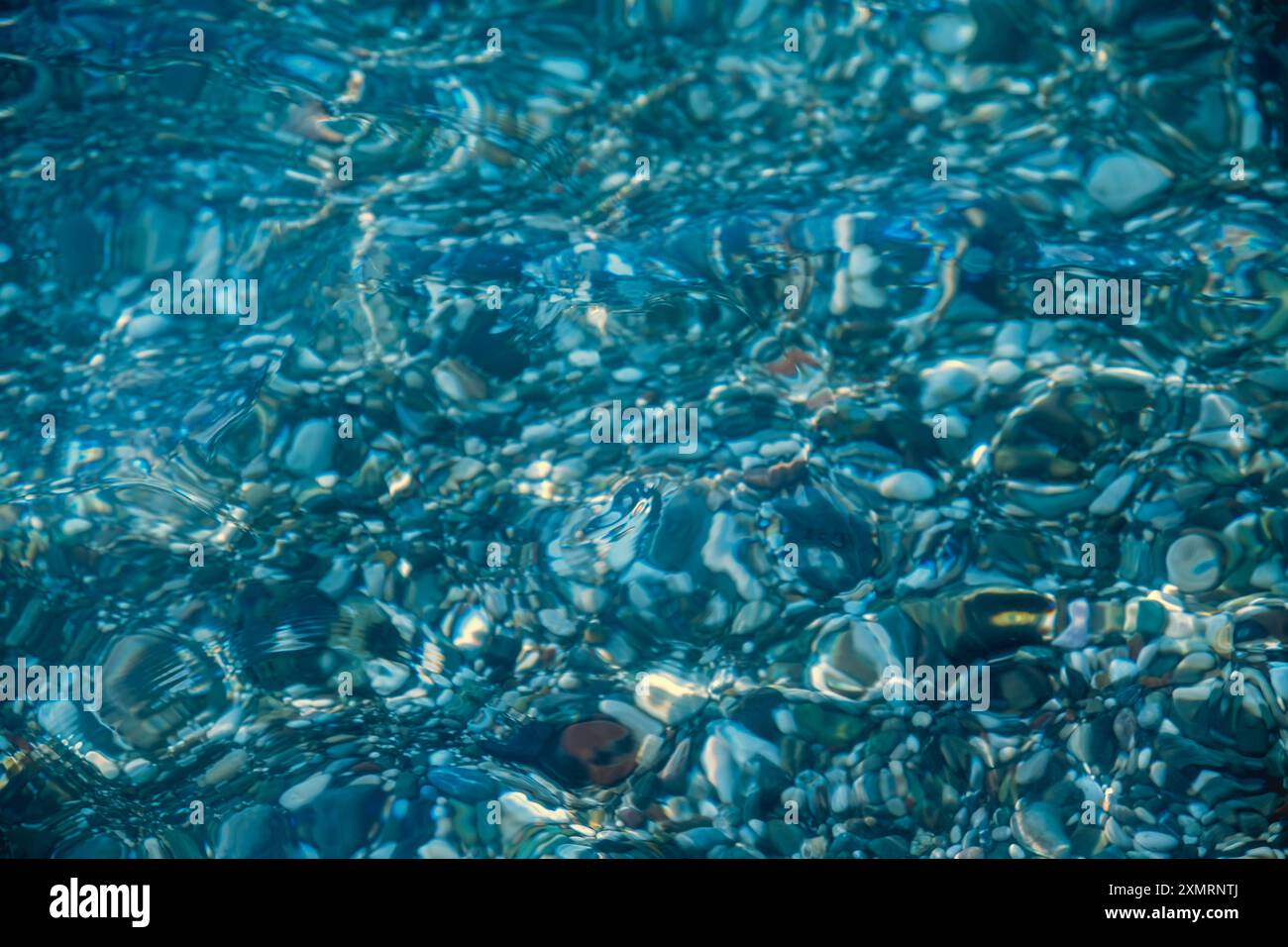 multi-colored stones under water on the sea, river. Natural background ...