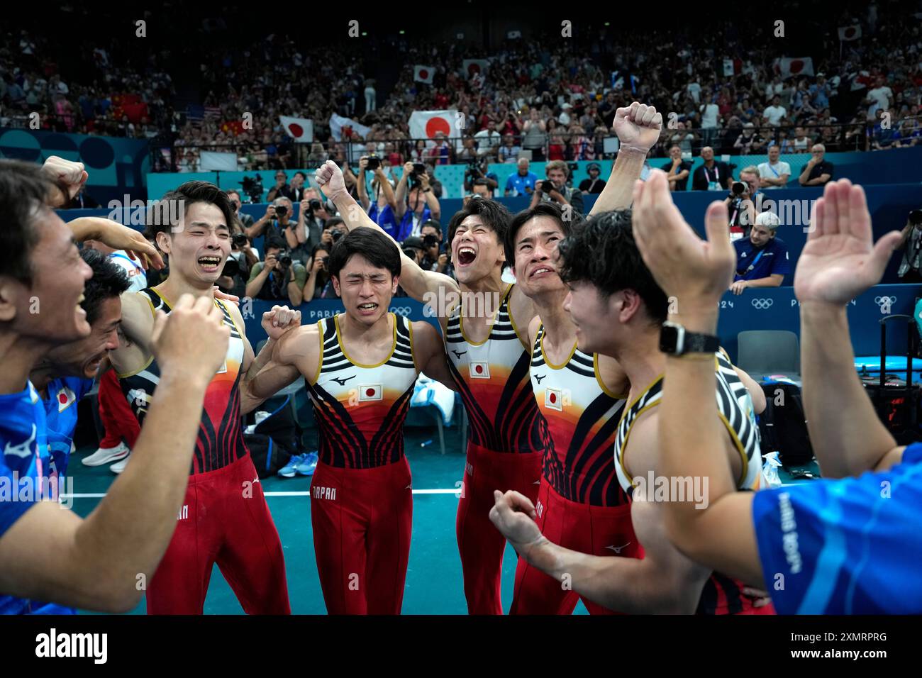 Members of team Japan celebrate after winning the gold medal during the ...