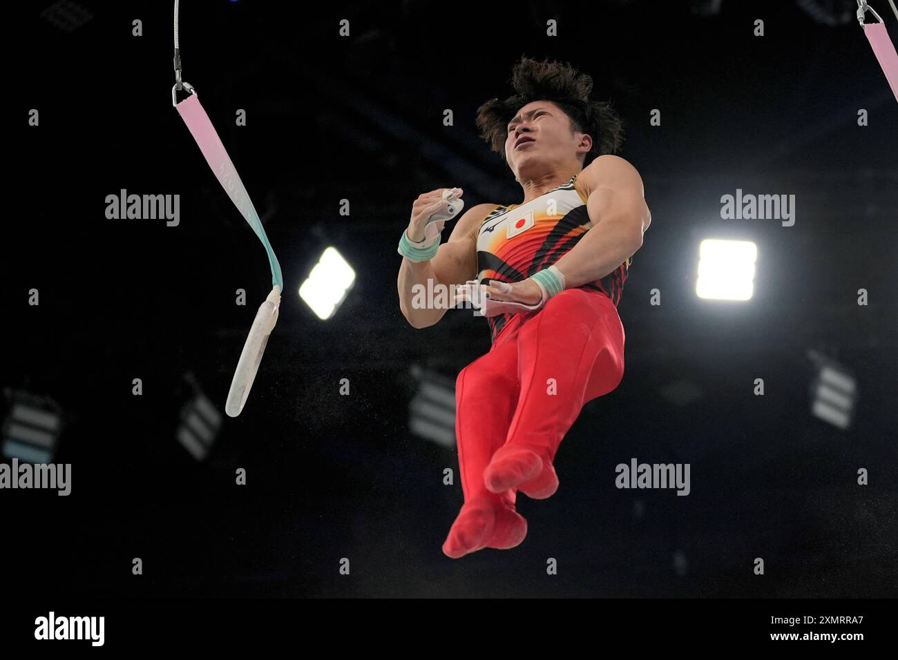 Shinnosuke Oka, of Japan, performs on the rings during the men's ...
