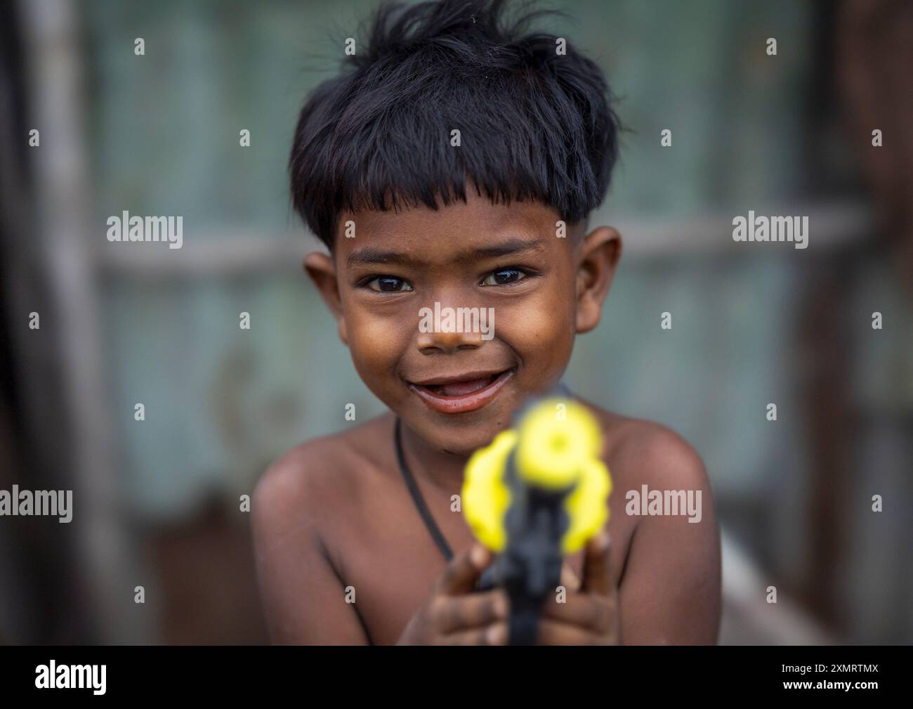 Portrait of a bangladeshi boy with a toy gun, Chittagong Division ...