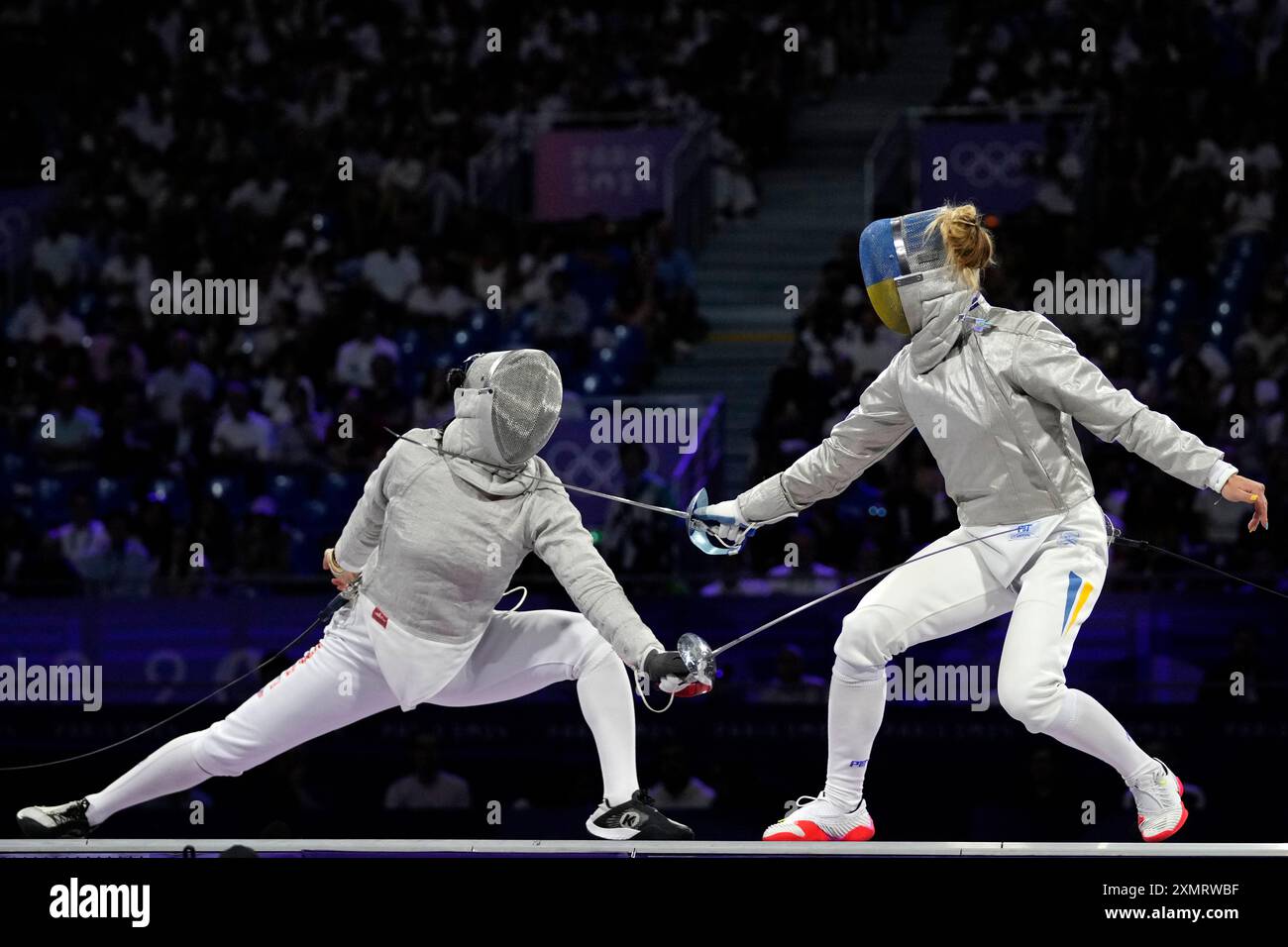 South Korea's Choi Sebin, left, competes with Ukraine's Olga Kharlan in ...