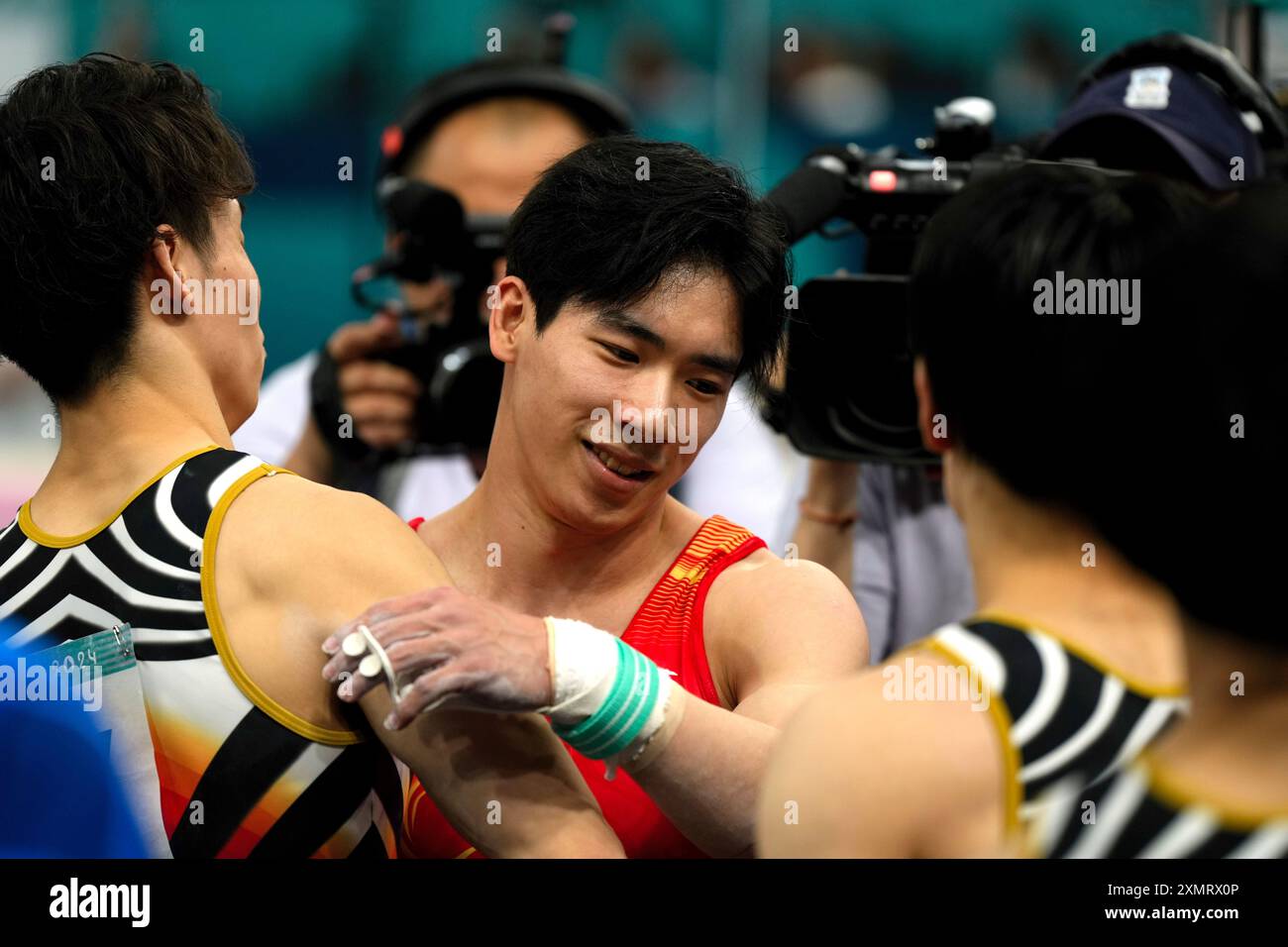 Zhang Boheng, of China, after performing on the horizontal bar during ...