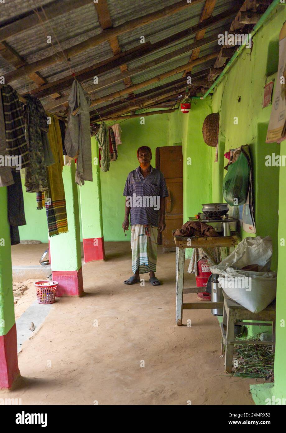 Bangladeshi man standing in the veranda of a green house, Rajshahi ...