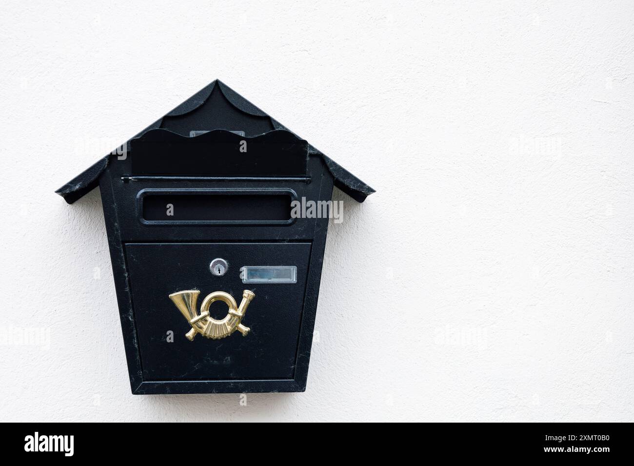 Traditional old black post box on pastel plaster texture wall in Hungry ...