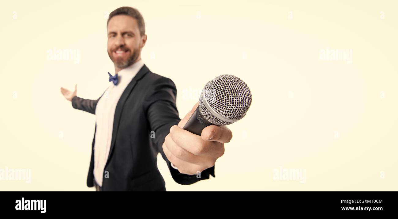 presenter man with microphone, copy space. man presenter wear tuxedo in ...