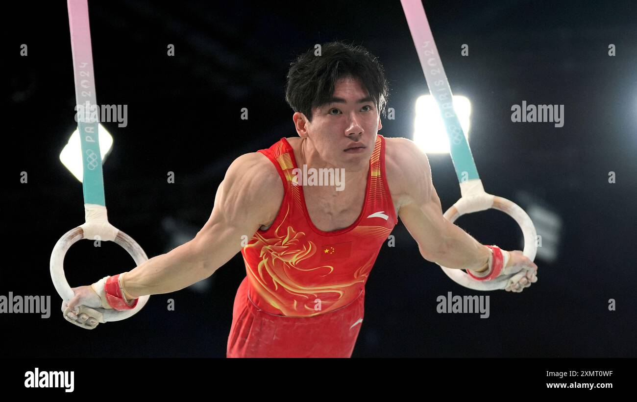 Zhang Boheng, of China, rings during the men's artistic gymnastics team ...